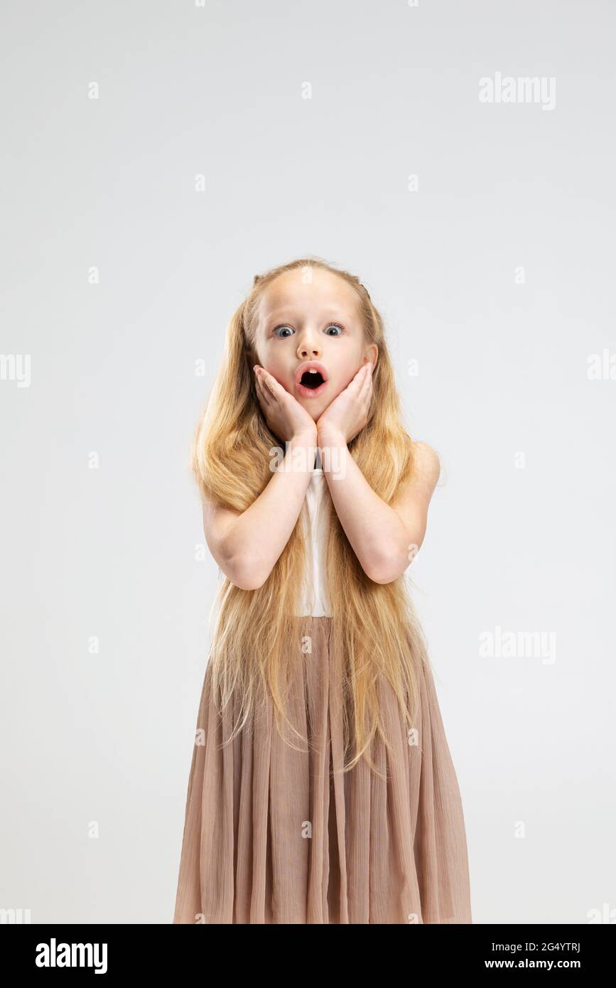 Beautiful little girl in modern stylish dress posing isolated on white ...
