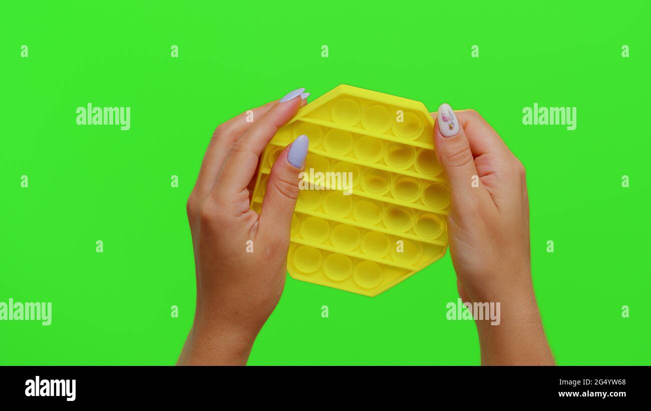 Girl hands squeezing presses colorful anti-stress touch screen push pop ...