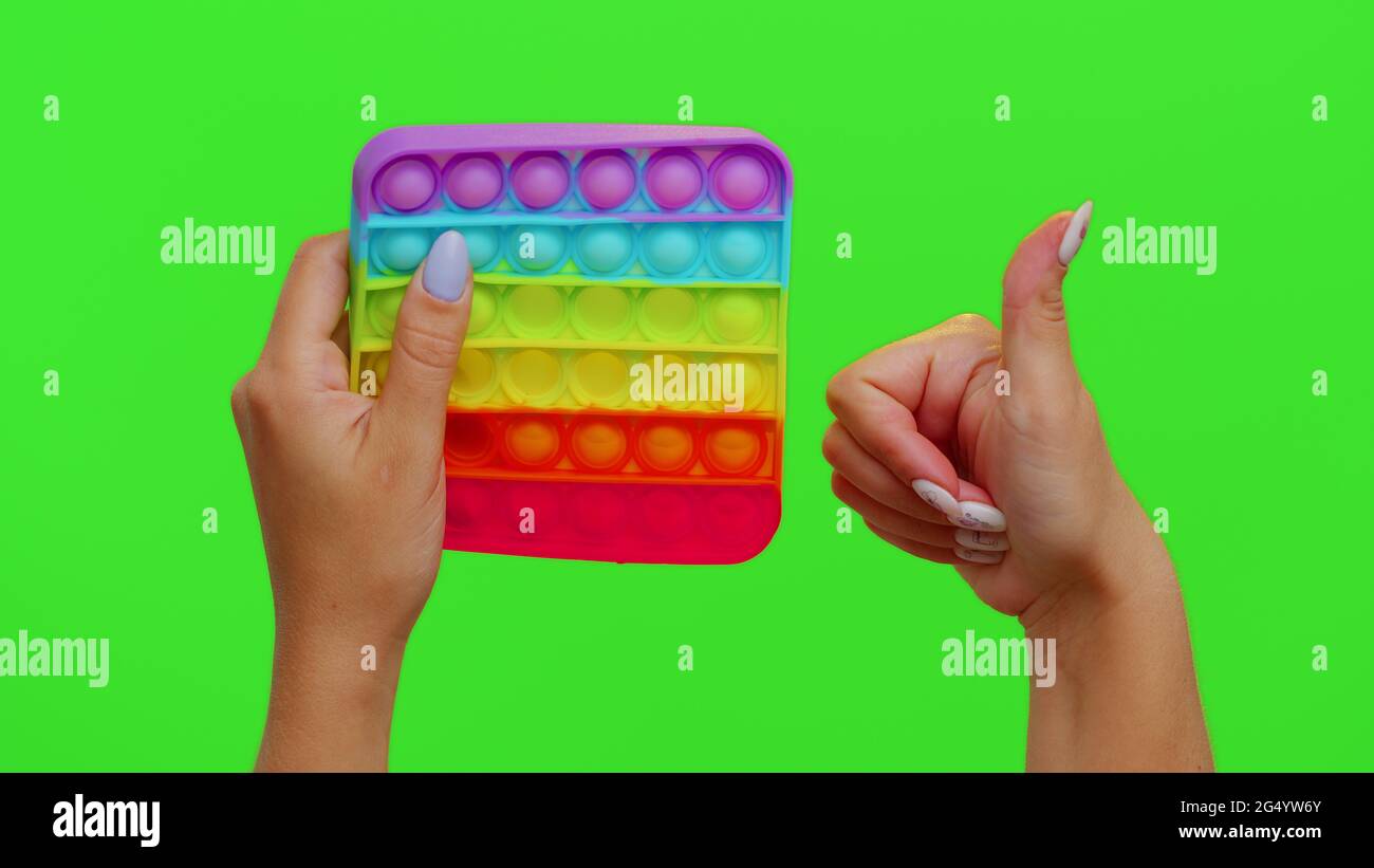 Female hands with push pop it bubble fidget stress anxiety relief ...