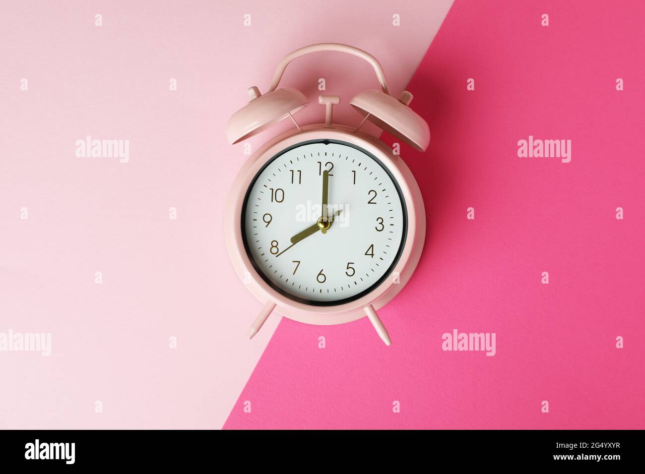 Stylish alarm clock on two tone background Stock Photo - Alamy