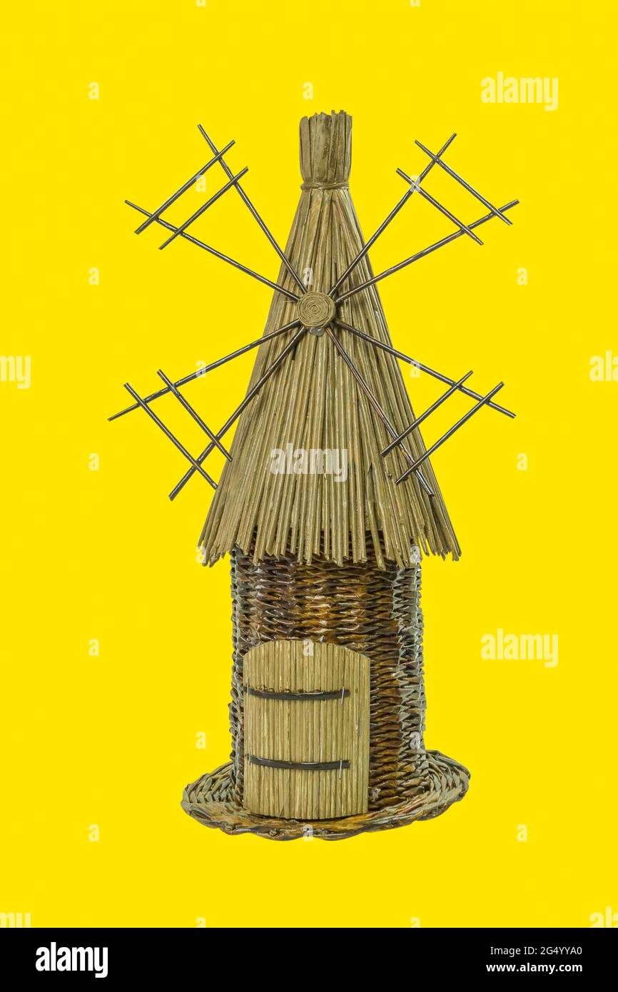 Straw mill on an isolated yellow background. Old windmill, mill as ...