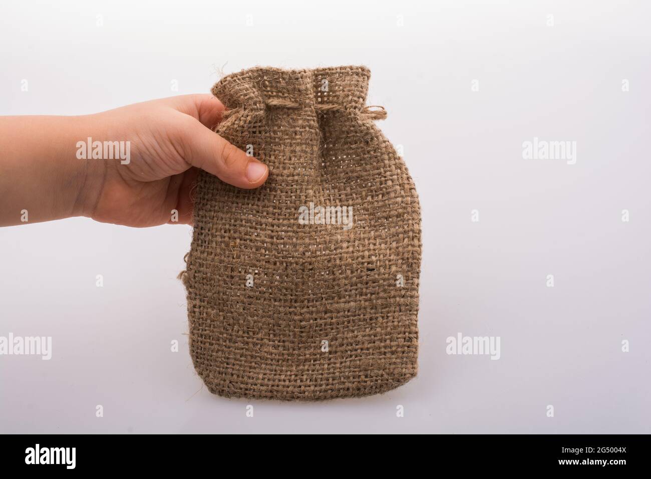 Closeup shot of a person holding a gunny sack over a white background ...