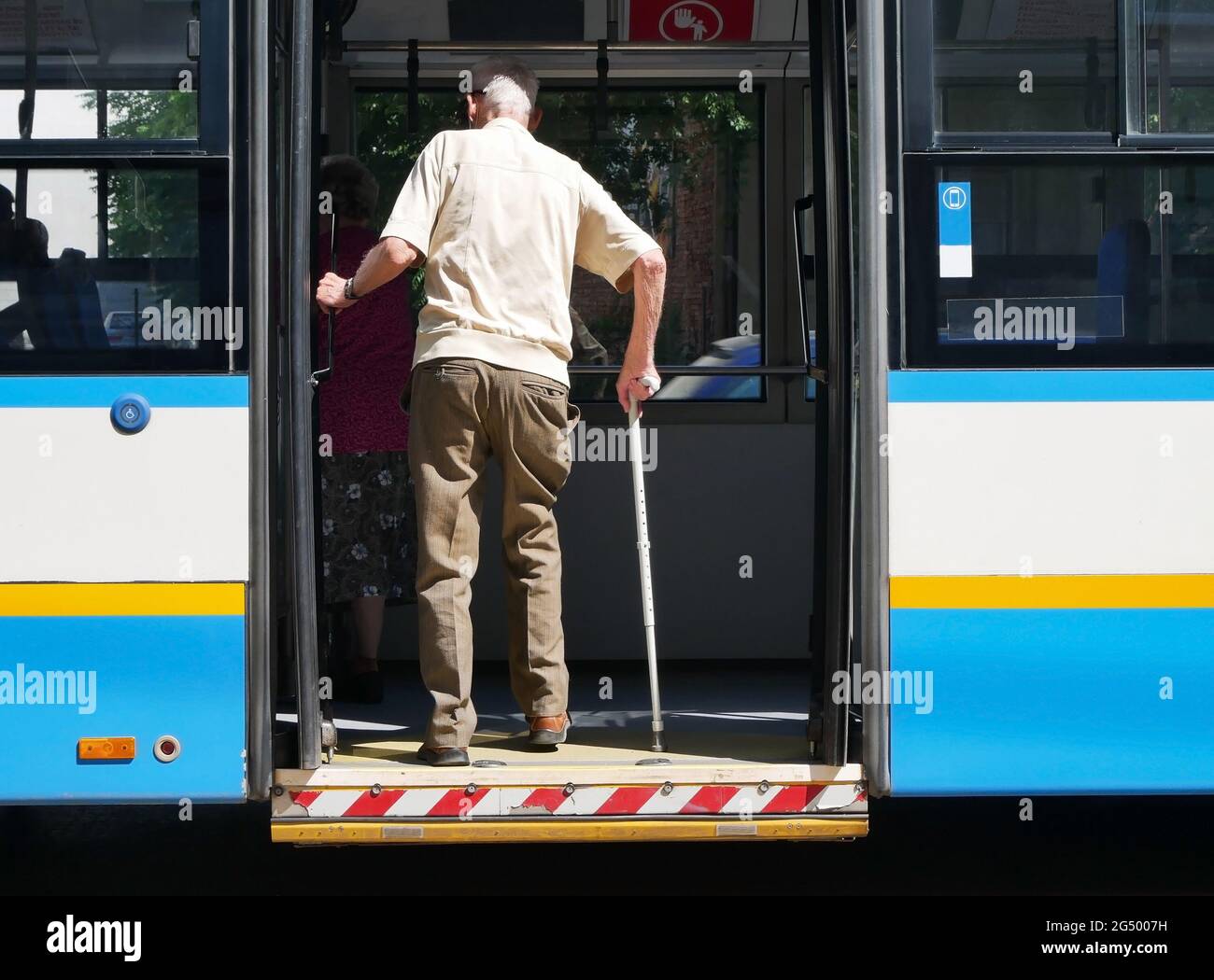 Old man is getting on the bus Stock Photo - Alamy