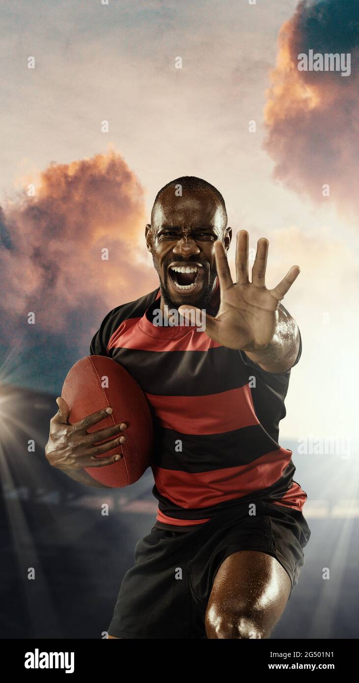 Professional male rugby player posing isolated on stadium background ...
