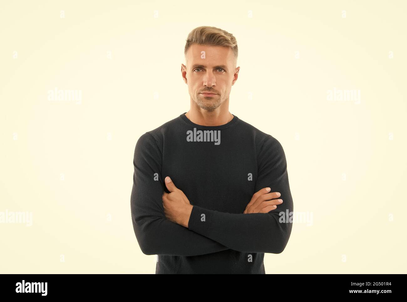 handsome unshaven man in casual style crossed hands isolated on white ...