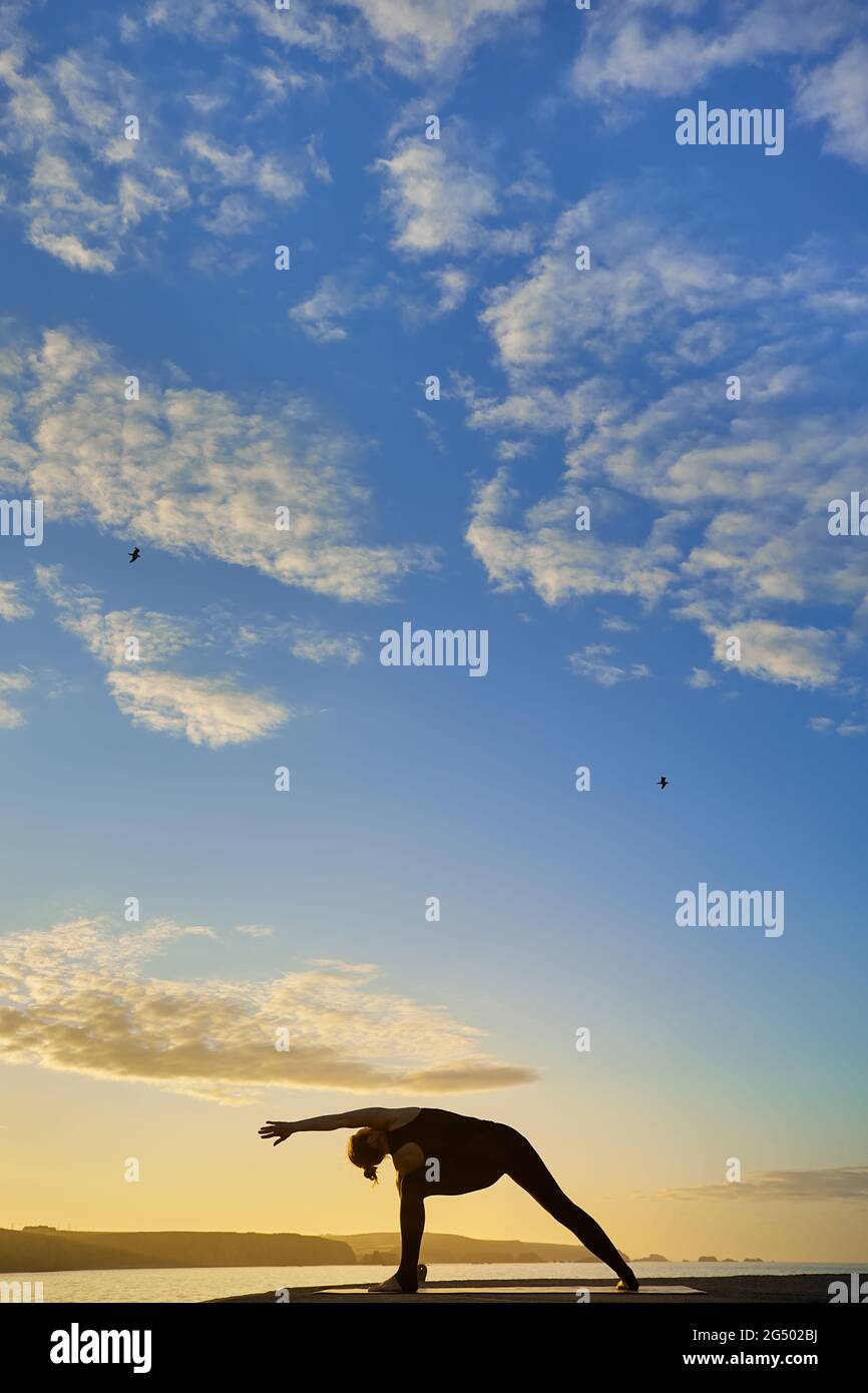 vertical photo of a woman doing yoga with large copy space Stock Photo ...