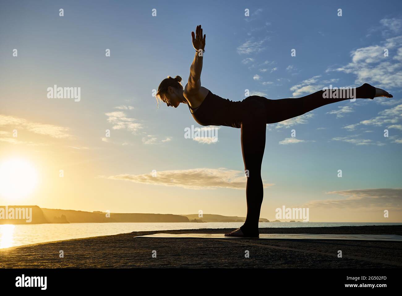 Lord of the Dance Yoga pose of a Caucasian woman backlight Stock Photo ...