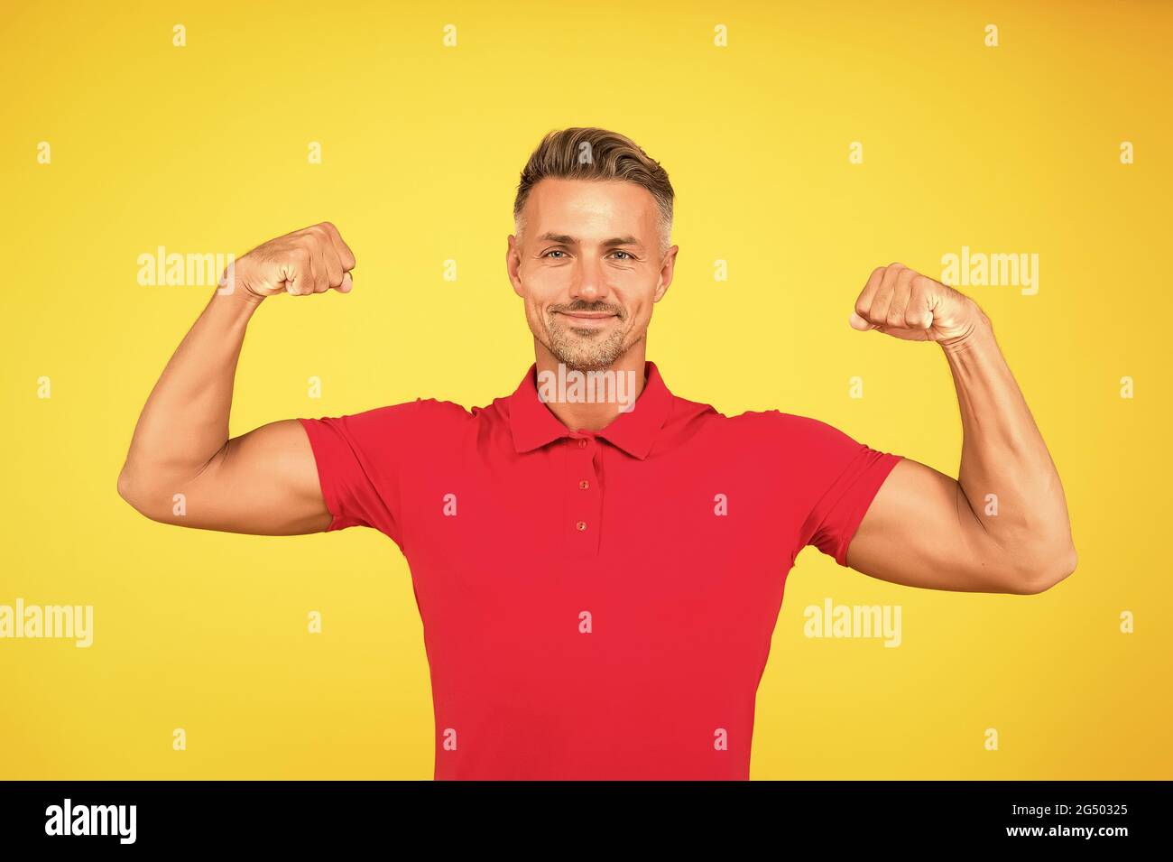 Commit to be fit. Strong man flex arms yellow background. Physical ...