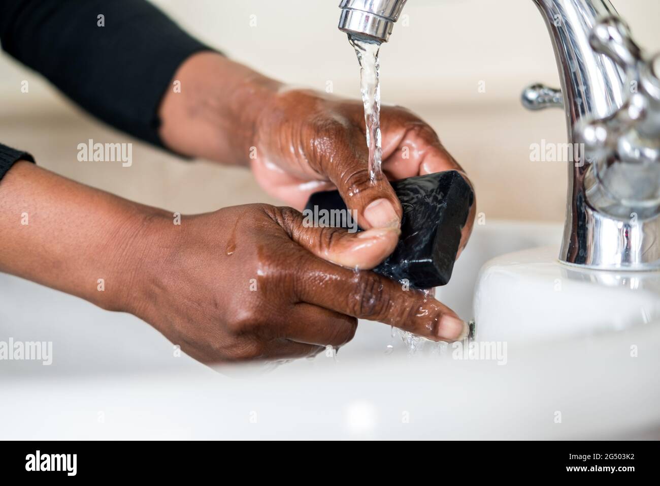 African lady washing her black hands with organic bamboo soap Stock ...