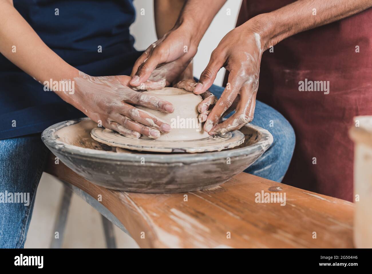partial view of young african american couple modeling wet clay on ...