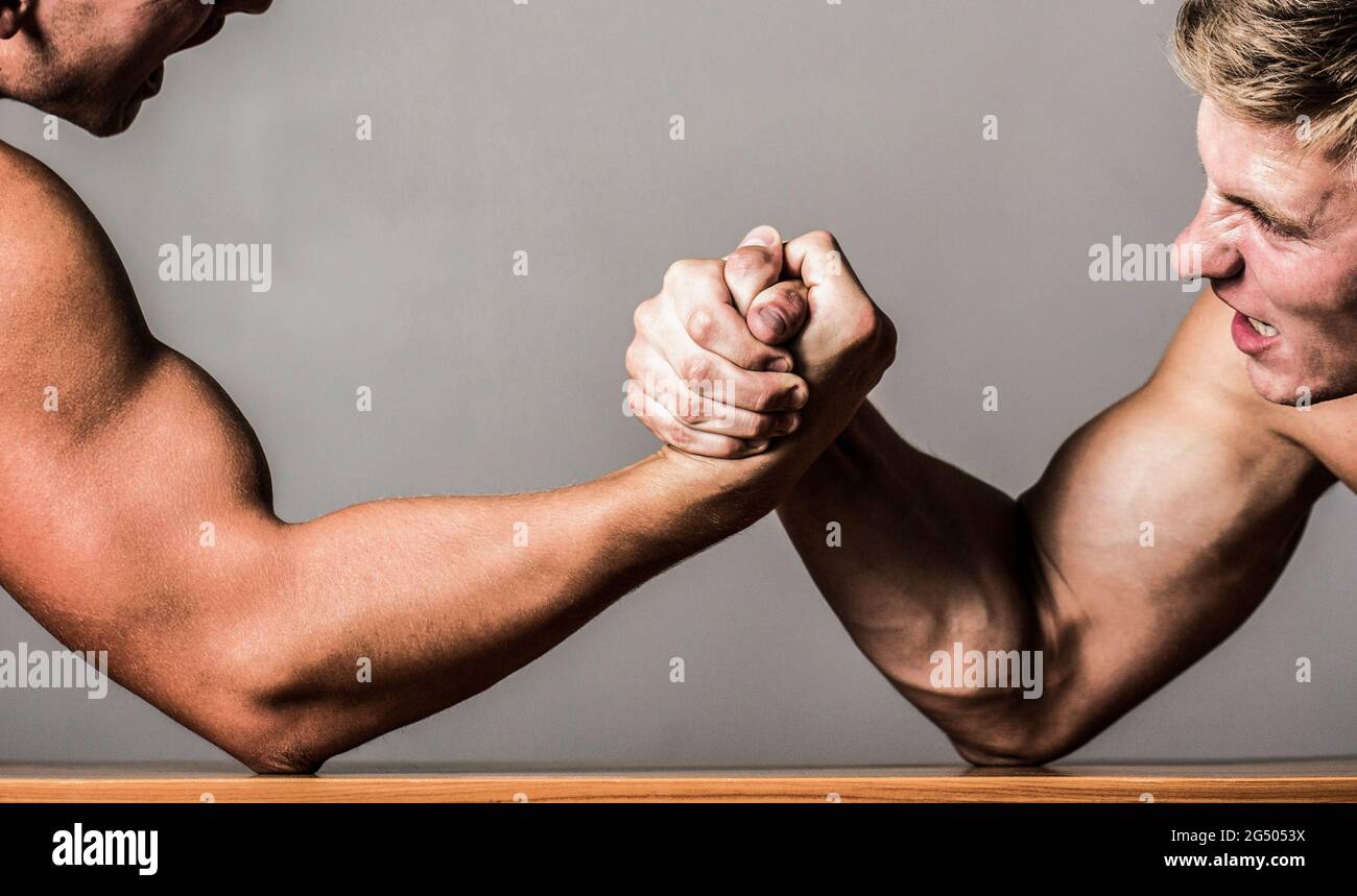 Arm wrestling. Two men arm wrestling. Rivalry, closeup of male arm ...