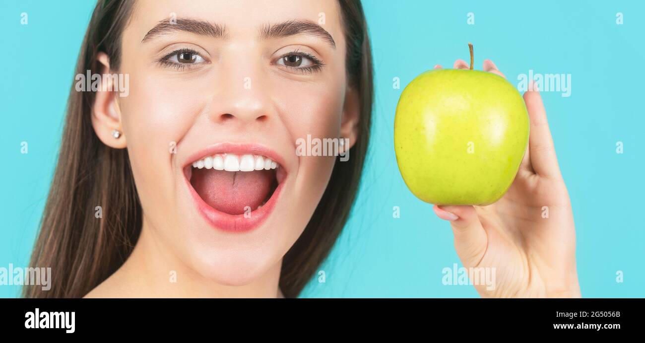 Stomatology concept. Woman with perfect smile holding apple, blue ...