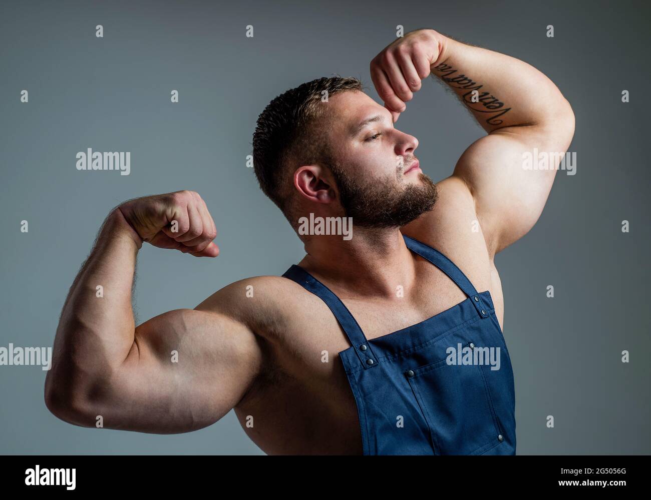 handsome man wear cook apron showing biceps muscles, strength Stock ...