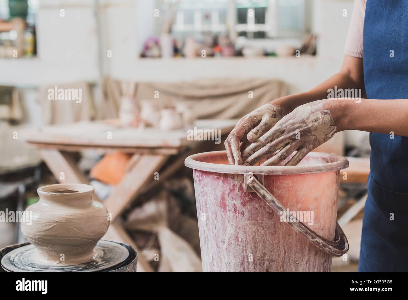 Woman washing clothes in bucket hi-res stock photography and images - Alamy