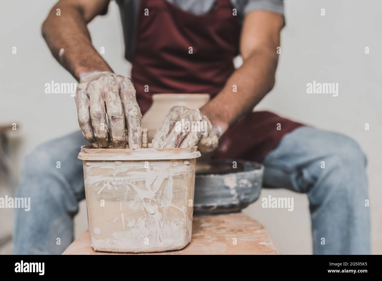partial view of young african american man washing sponge in plastic ...
