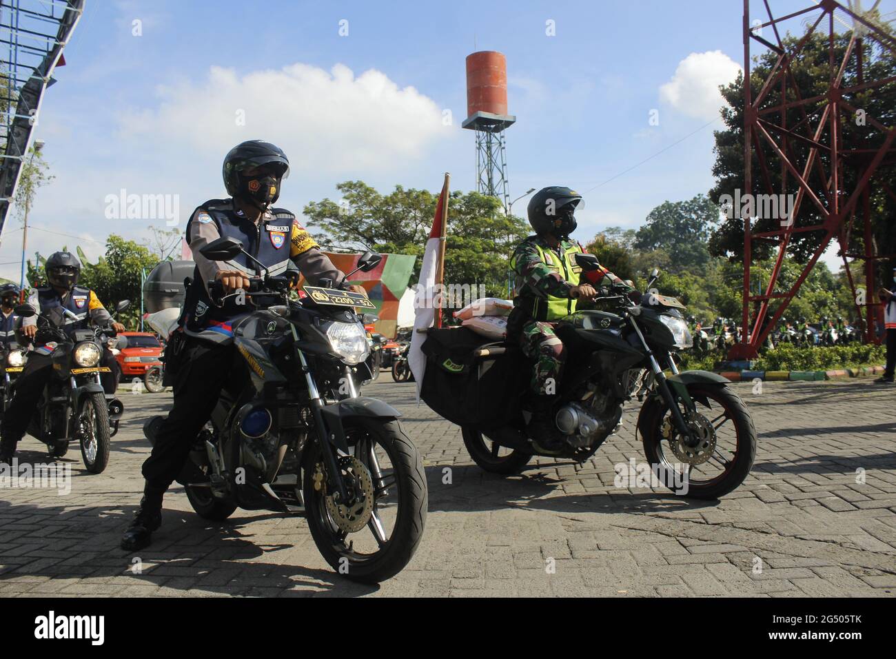 Madiun, Indonesia. 24th June, 2021. TNI personnel riding motorcycles ...