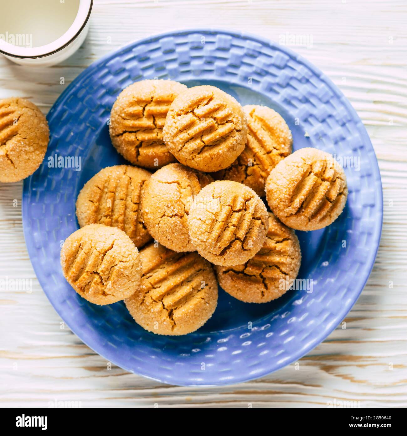 Peanut cookies in blue plate on white wooden background Stock Photo - Alamy