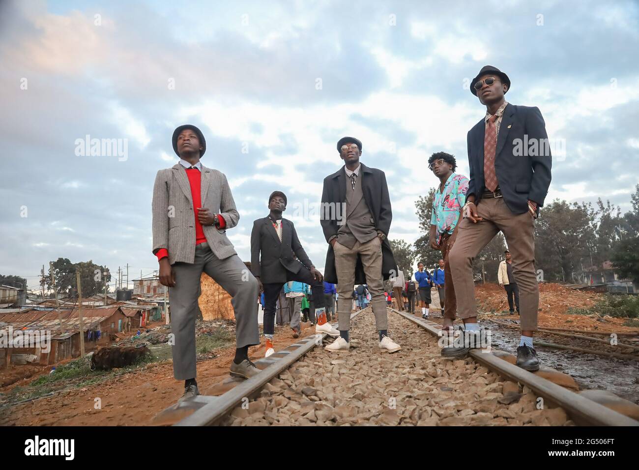 A group of street models match through the streets in Kibera Slums ...