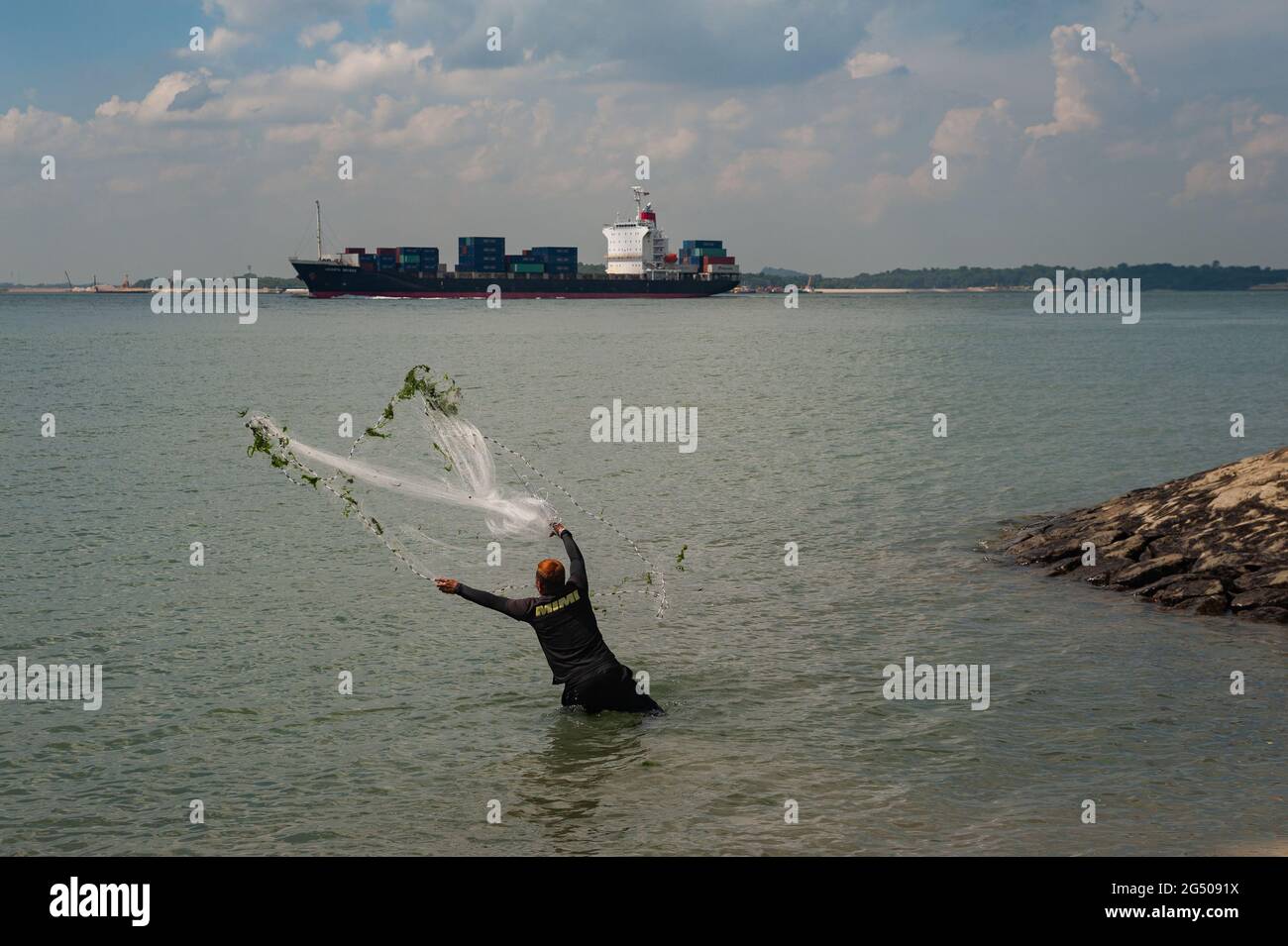 23.06.2021, Singapore, Republic of Singapore, Asia - A man casts his ...