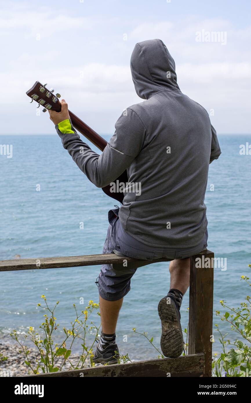 Man sitting on railing hi-res stock photography and images - Alamy