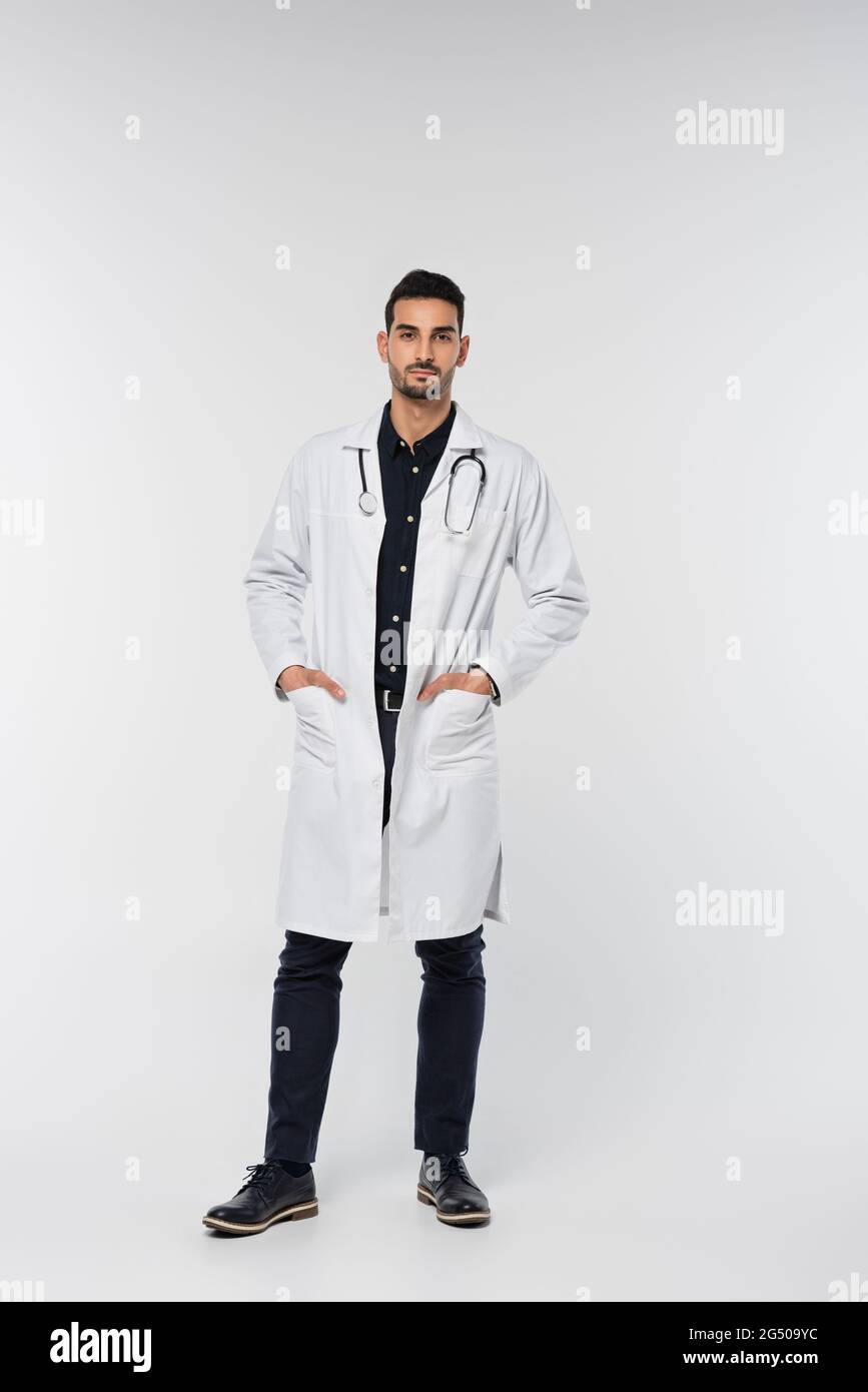 Arabian doctor looking at camera on grey background Stock Photo - Alamy