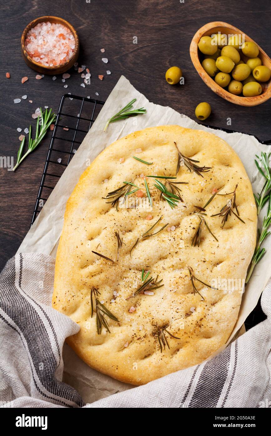 Italian traditional focaccia bread baking with aromatic seasonings and ...