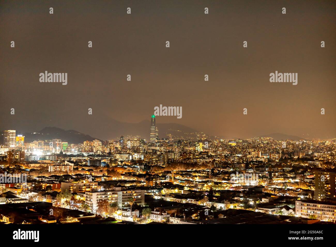 Panoramic view of Santiago Chile at night. City lights on a cloudy ...
