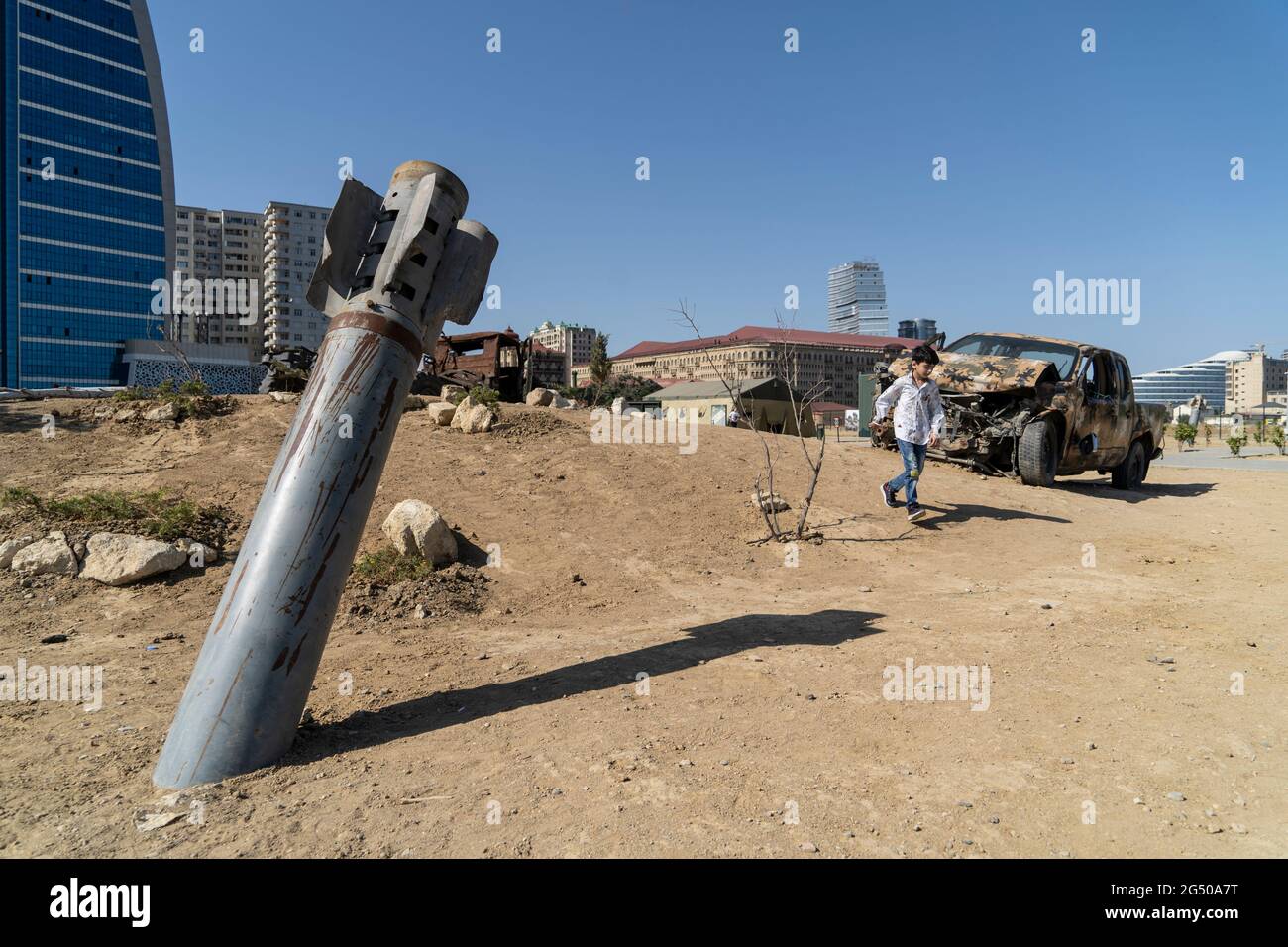 Azeri child runs past an Armenian rocket on display in Trophy Park ...