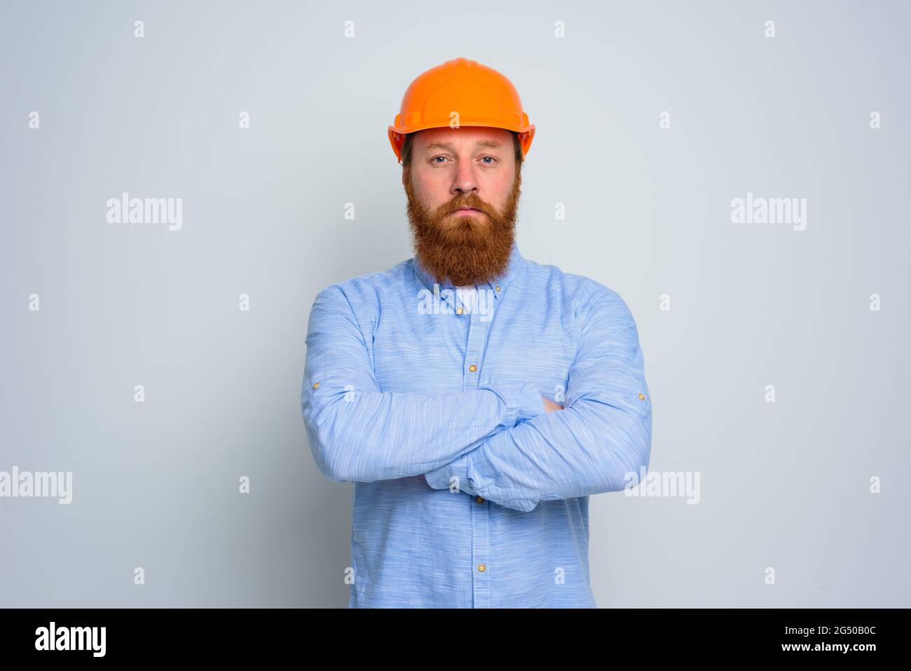 Isolated confidant architect with beard and orange helmet Stock Photo ...