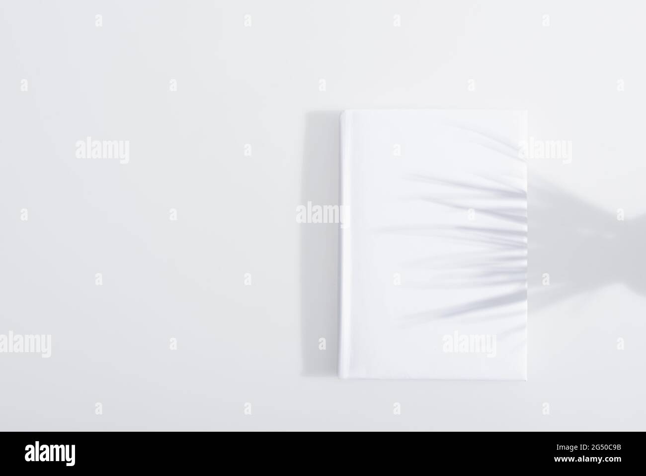 shadow on hardcover of book on white background Stock Photo - Alamy