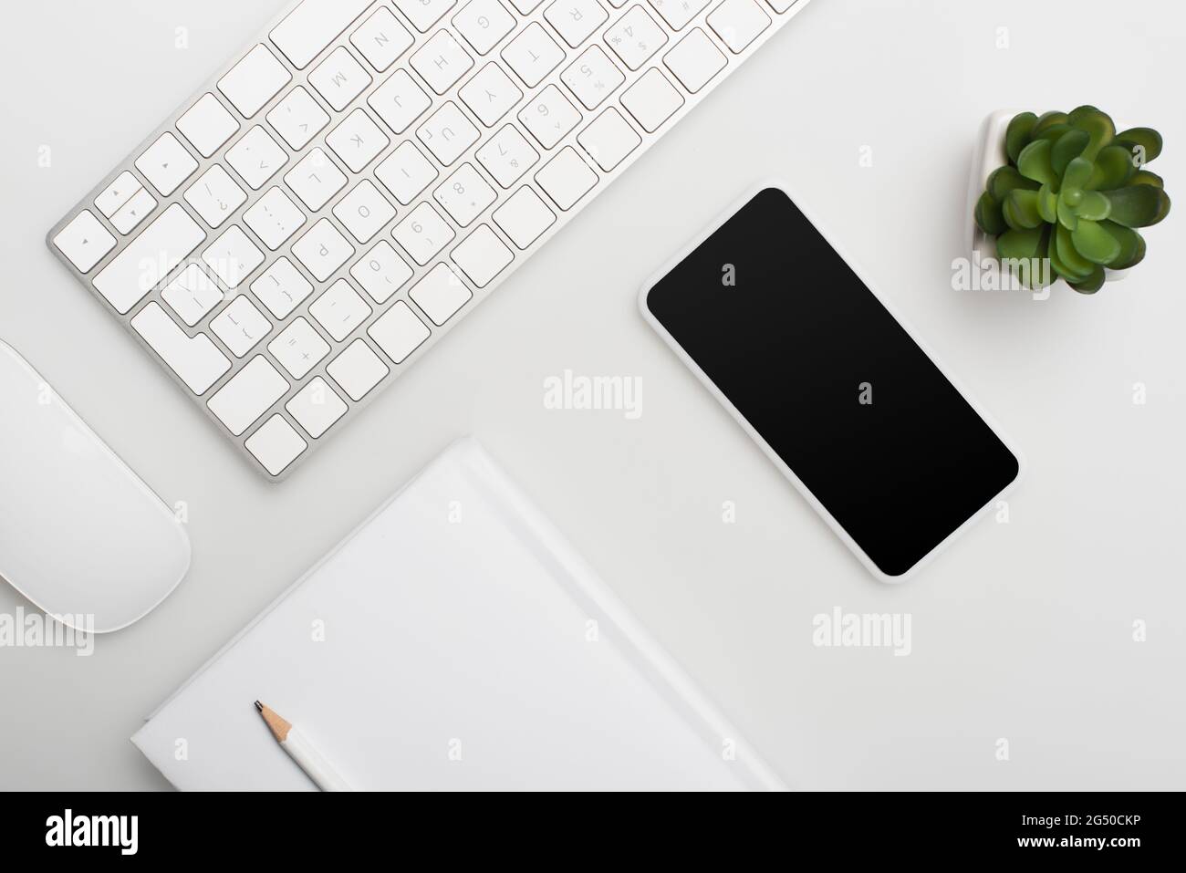 flat lay with computer mouse and keyboard near notebook, smartphone and ...