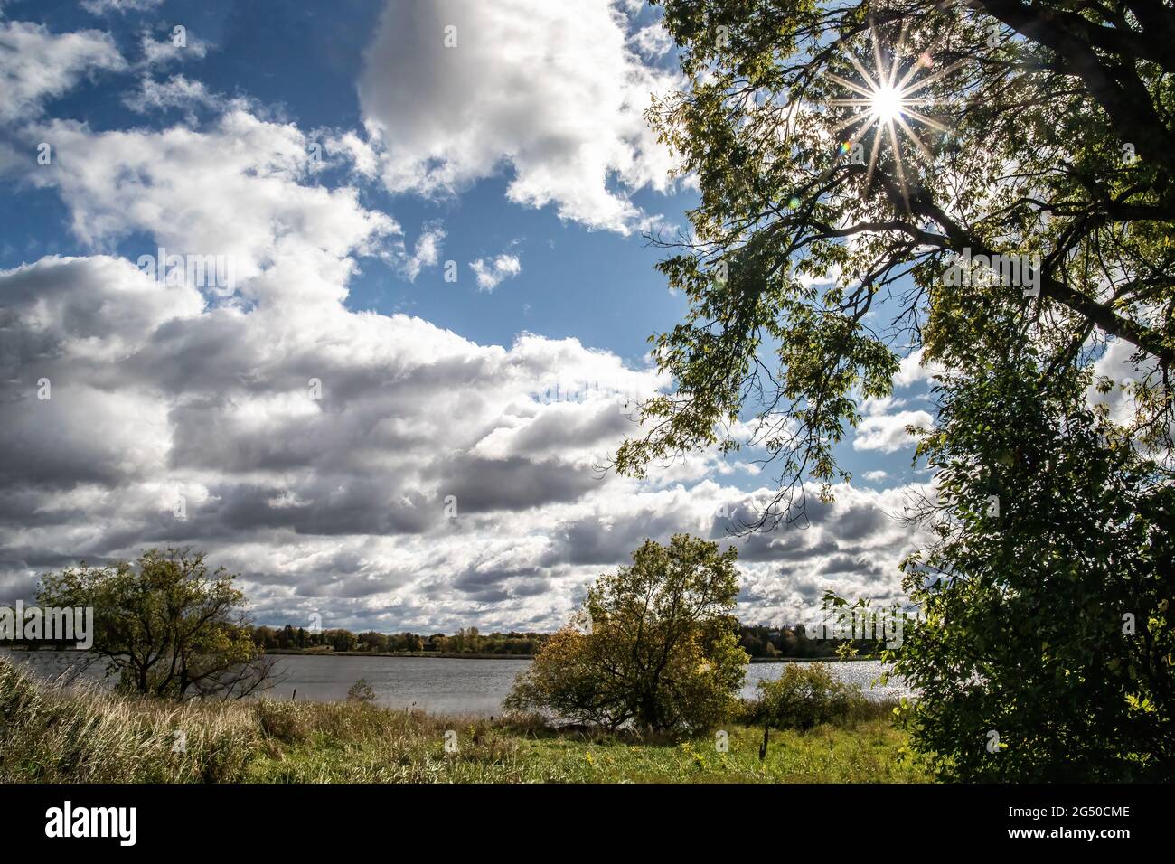 Sun shining through the trees with a view of Moody Lake at Moody Lake ...