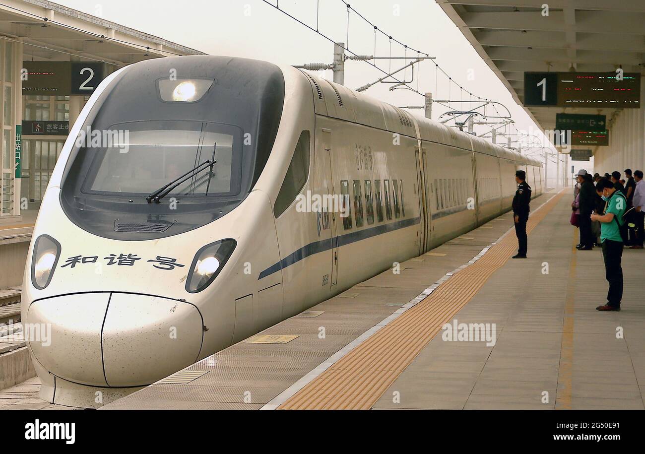 Chinese travelers wait for a high-speed train to arrive at Tianshui's ...