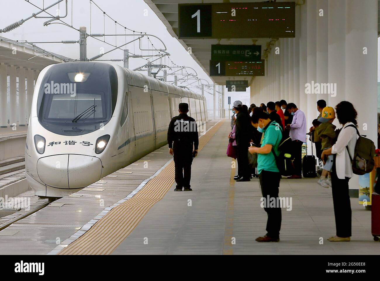 Chinese travelers wait for a high-speed train to arrive at Tianshui's ...