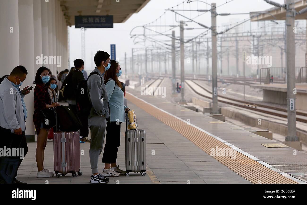 Chinese travelers wait for a high-speed train to arrive at Tianshui's ...