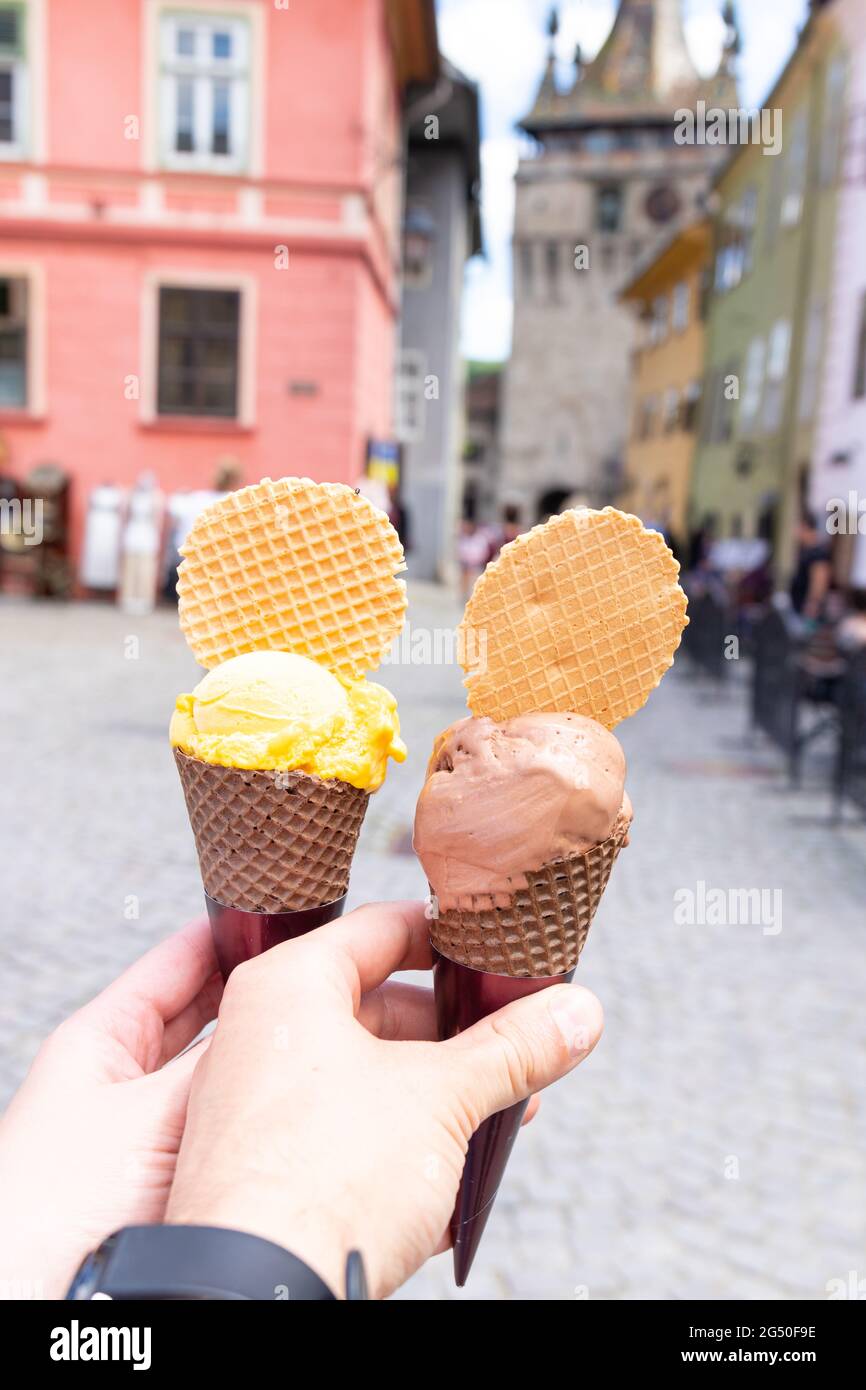 ice cream in the city. Couple holding two ice creams in their hands in ...