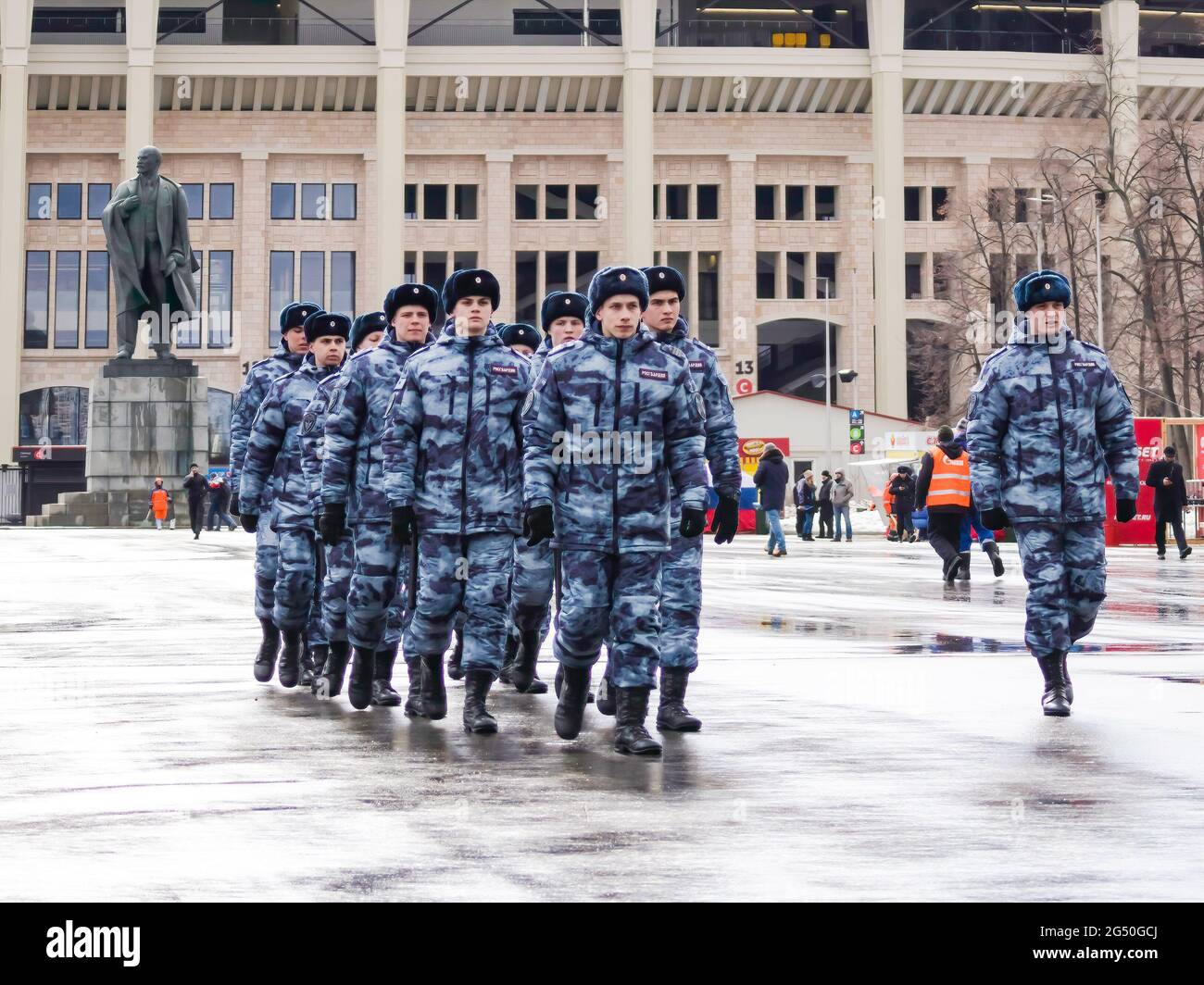A branch of the Russian Guard marching along the alley in front of the ...