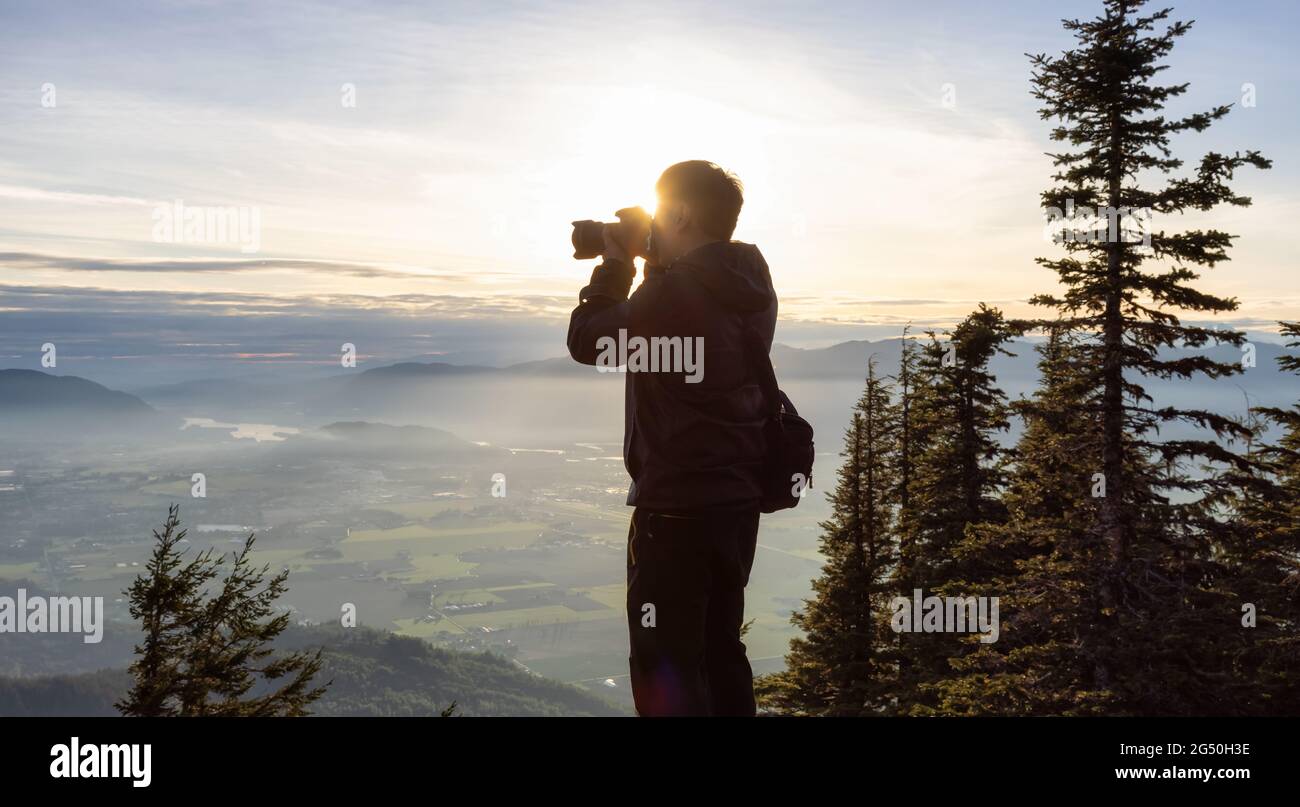 Adventure Photographer taking pictures while Hiking in Canadian Nature ...
