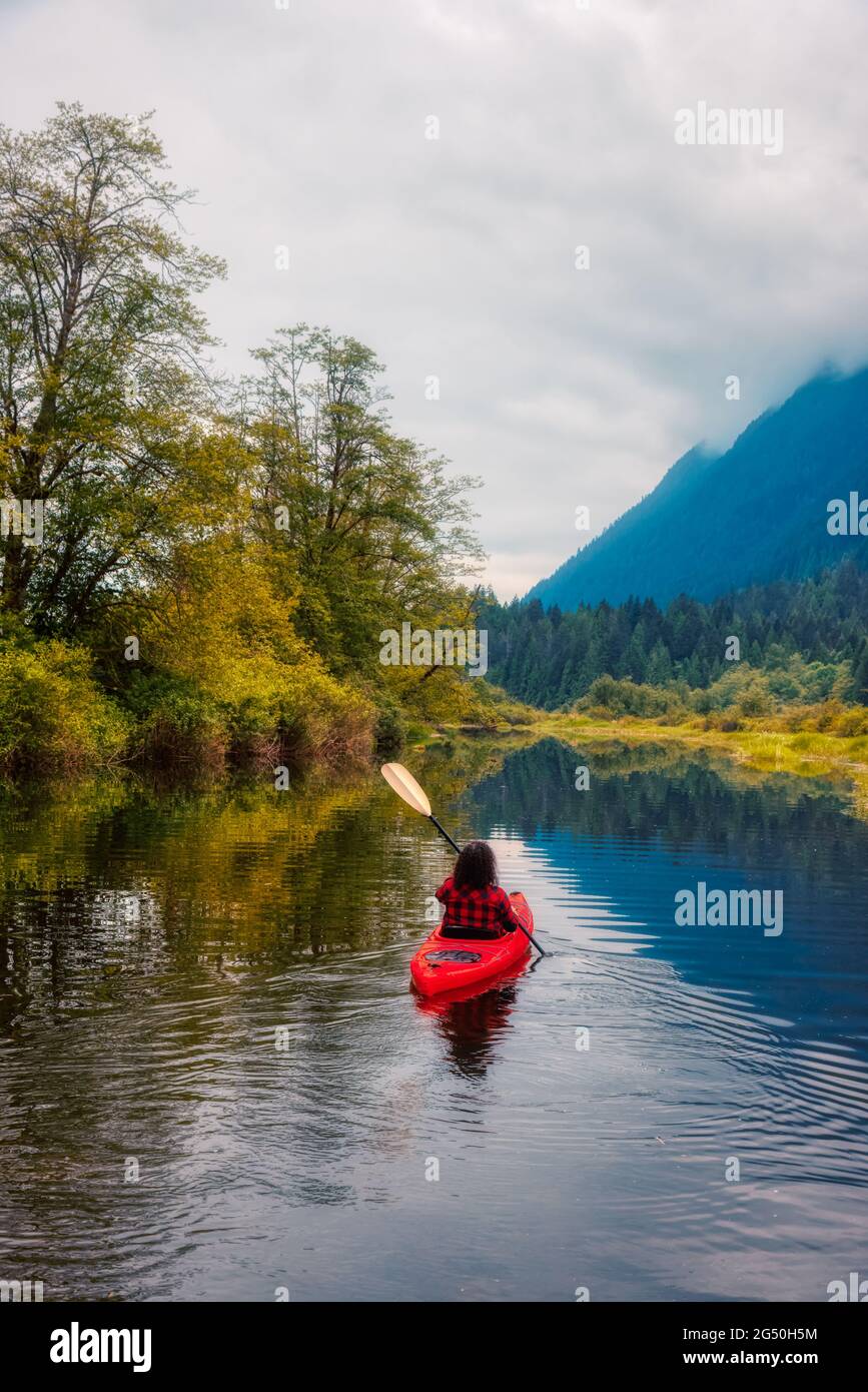 Adventure Caucasian Adult Woman Kayaking in Red Kayak Stock Photo - Alamy