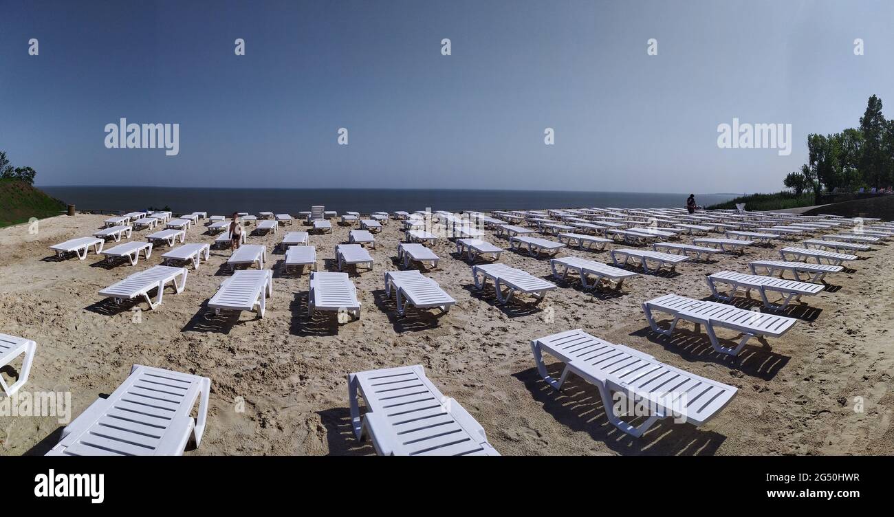 white sunbeds on the sea sandy beach Stock Photo - Alamy