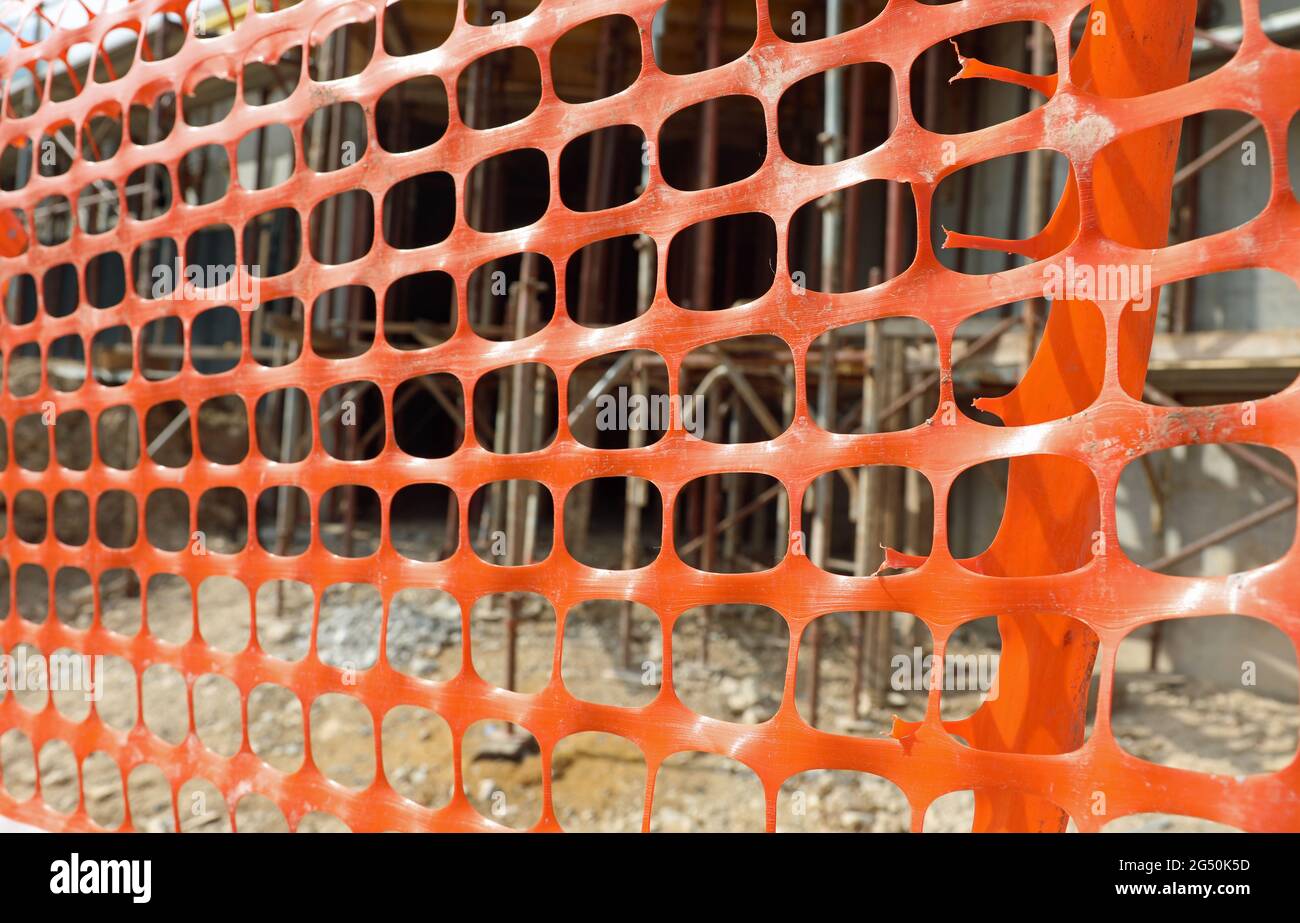 orange plastic net for the protection of the construction site during ...