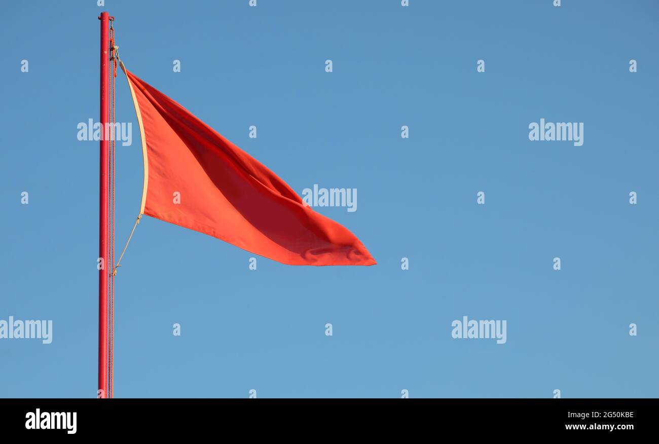 big red flag symbol of emergency or danger sign with the background of ...