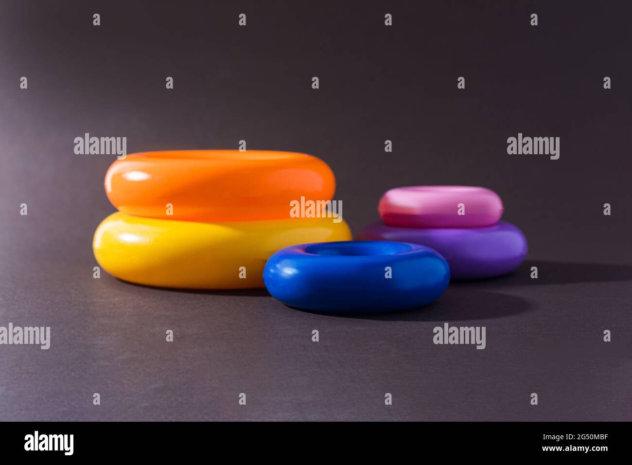 Set of colorful plastic rings on black backround Stock Photo - Alamy