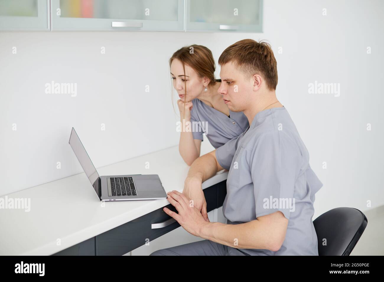 Group of cheerful healthcare workers working together at doctor's ...