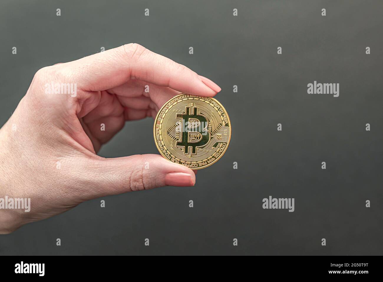 bitcoin in hand, female hand holds a gold bitcoin coin. Cryptocurrency ...