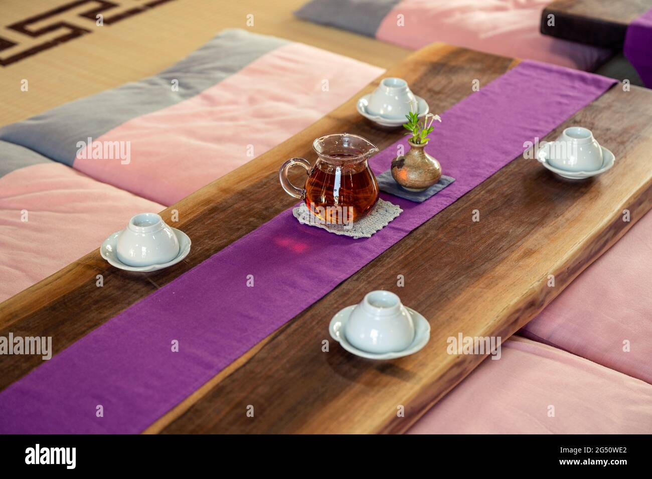 Set of tea jug with teacup and plant in vase on timber at teahouse ...