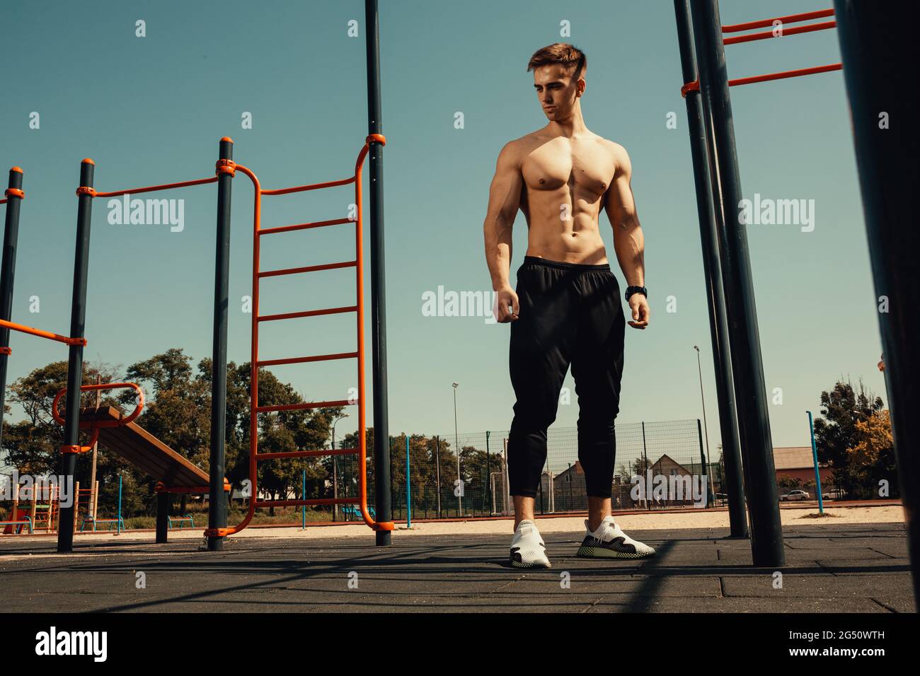 guy with a beautiful athletic body posing while standing next to the ...