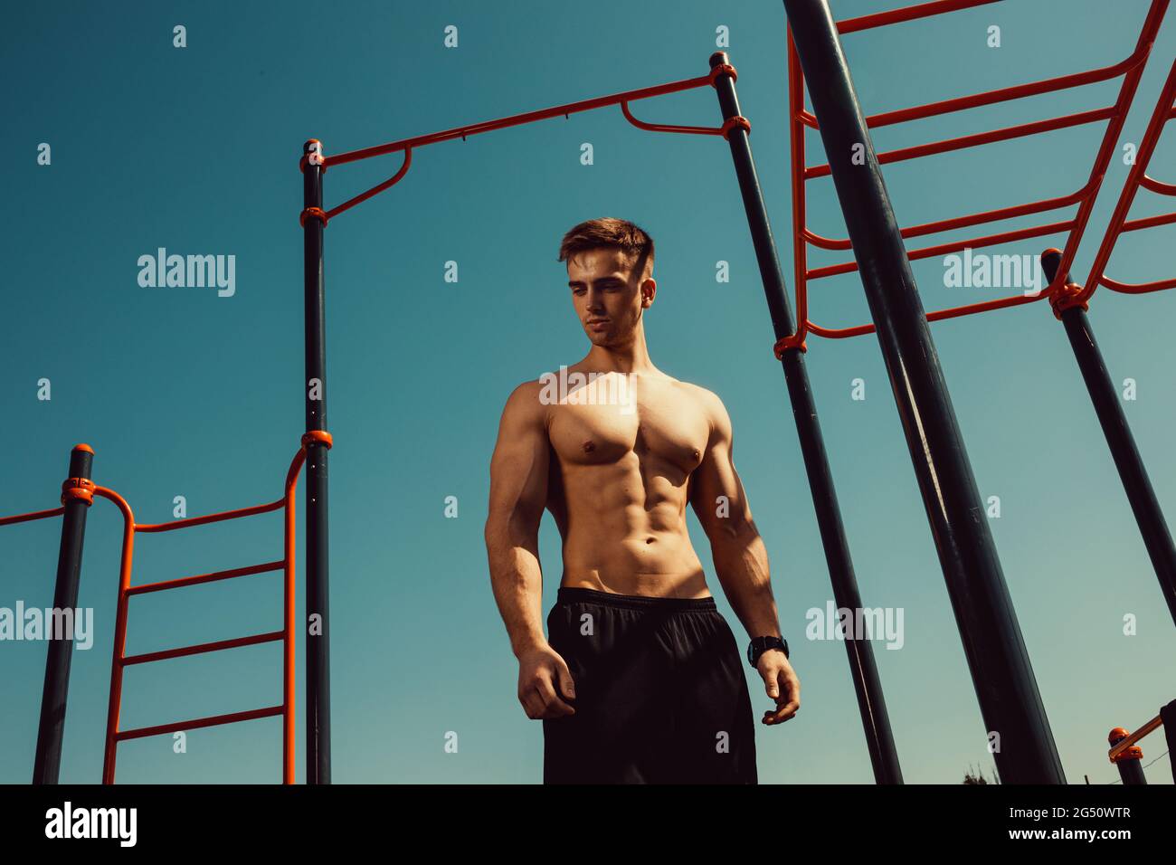 guy with a beautiful athletic body posing while standing next to the ...