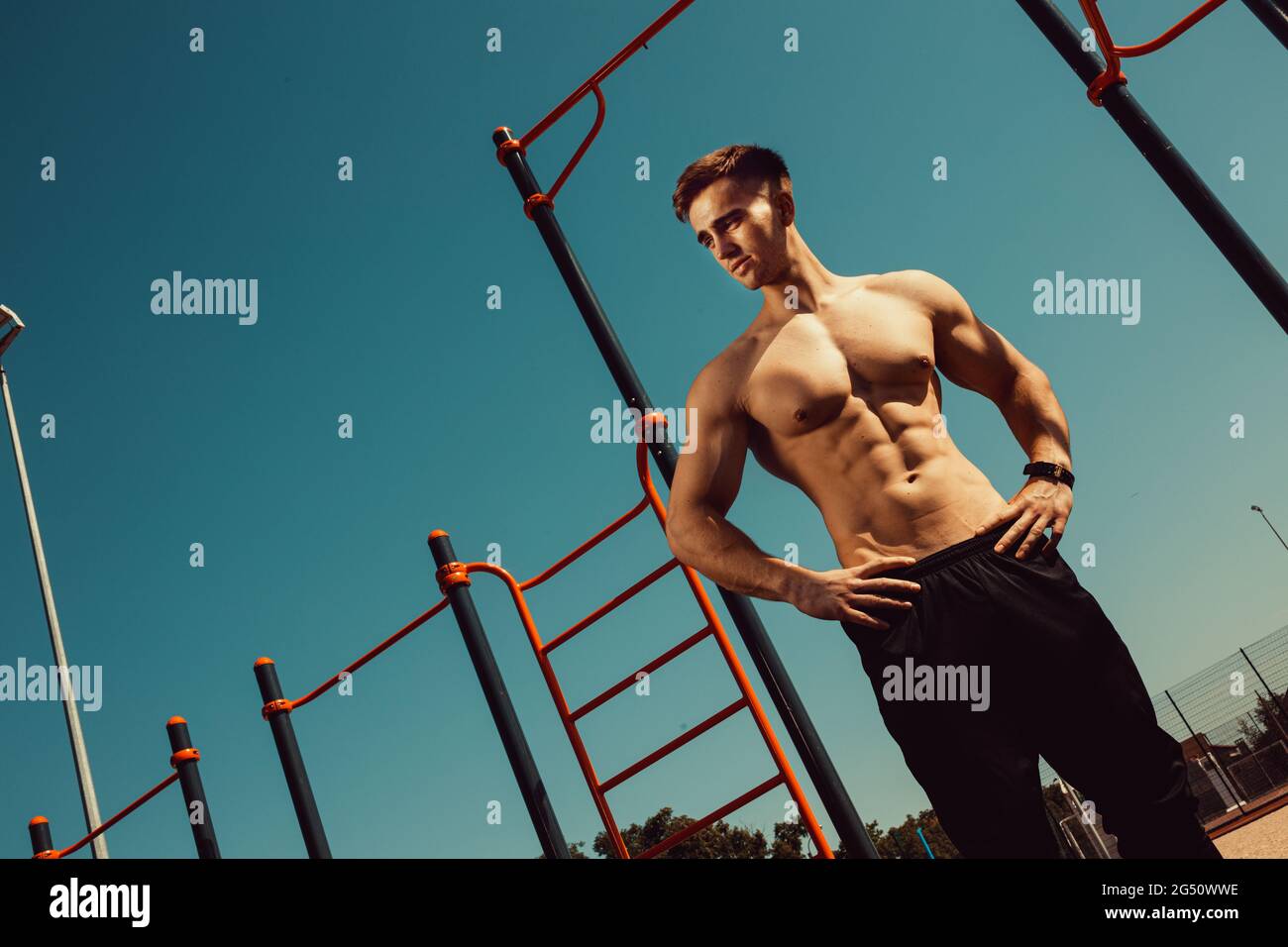 guy with a beautiful athletic body posing while standing next to the ...