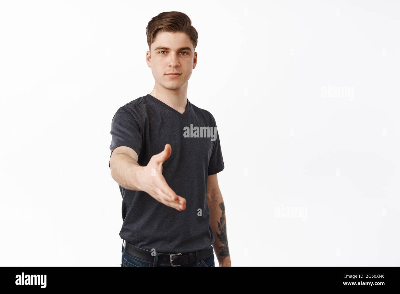 Confident young man stretching hand for handshake, nice to meet you ...